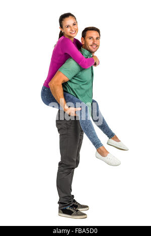 Beautiful couple piggy back in autumn smiling Stock Photo - Alamy