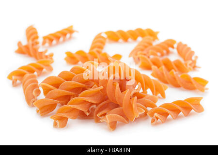 Orange swirl dry pasta closeup isolated on white background Stock Photo ...