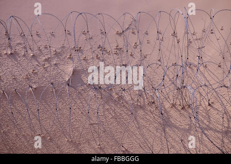 Coiled barbed wire fence at the Israeli border with the northern Gaza ...