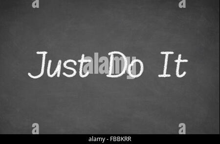 Motivational phrase, just do it, handwritten with white chalk on a ...