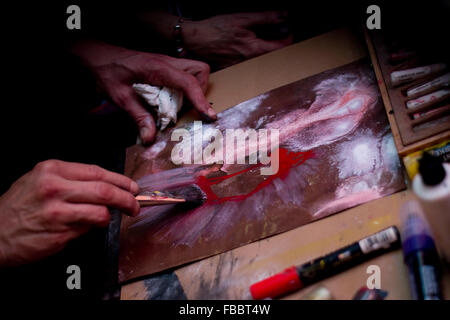 Artist hands brush painting abstract blue teal colors on canvas ...