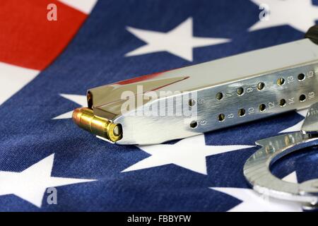 Handcuffs and ammunition on United States Flag Stock Photo - Alamy