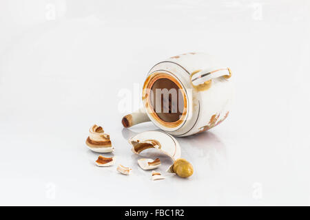 The fall shattered teapot on a white background Stock Photo - Alamy