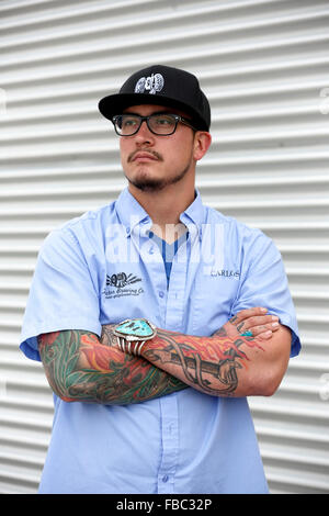 Young hispanic man with beard and tattoos working at the office at ...