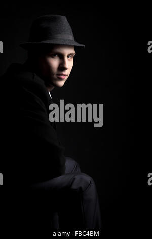 Portrait of elegant young man wearing winter coat and wide scarf ...