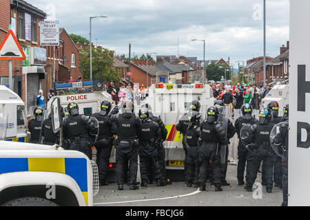 Line of PSNI Officers in riot gear, with armoured landrovers and Stock ...