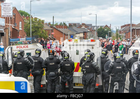 PSNI riot police officers line up behind a water cannon being used on ...