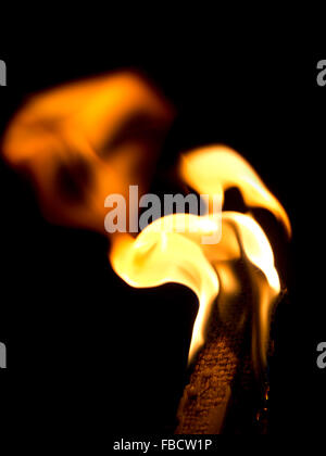 Fire flame at night with dark background during the ganga aarti rituals ...