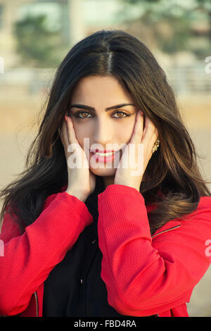 Happy young woman touching her cheeks on yellow background Stock Photo ...