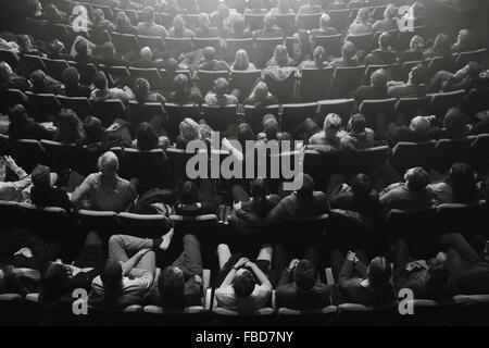 Rear view of theater audience watching performers on stage Stock Photo ...
