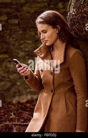 Young Woman looking at cellphone in the city Stock Photo - Alamy