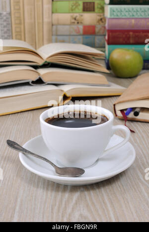stack book and cup of coffee on wooden table. Light background Stock ...
