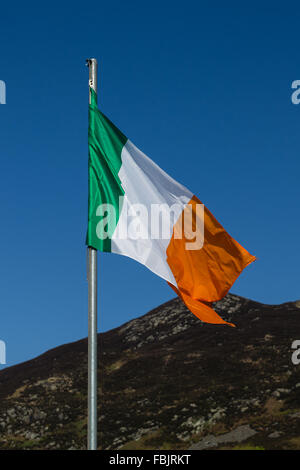 Irish tricolour green white and orange flag flying from a house in a ...