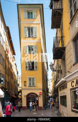 Narrow street with tall, colorful buildings and small balconies in an ...