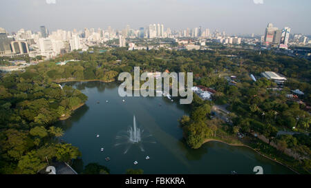 A aerial drone view over Lumpini Park in Bangkok, Thailand looking east ...