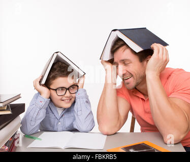 Father and his son hiding under table in kitchen during earthquake ...