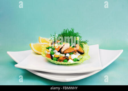 Salad of mussels with corn and peas in the leaves of savoy cabbage on a ...