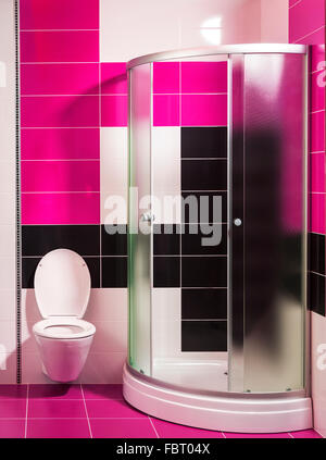 Modern bathroom with pink and white tiles, rain head, hand held shower ...