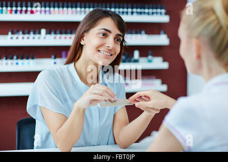 Adult woman client doing nails in nail salon in afternoon Stock Photo ...
