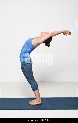 Beautiful woman practices backbend yoga asana Urdhva Dhanurasana ...