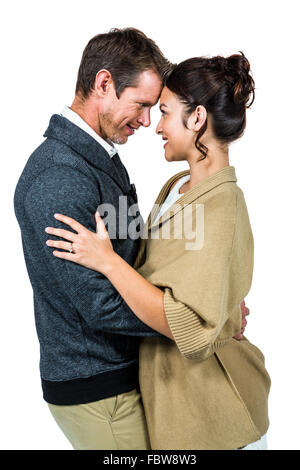 Side view of attractive couple hugging and sitting by the table in cafe ...