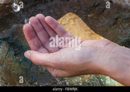 Closeup image of a hand splashing water in the pool Stock Photo - Alamy