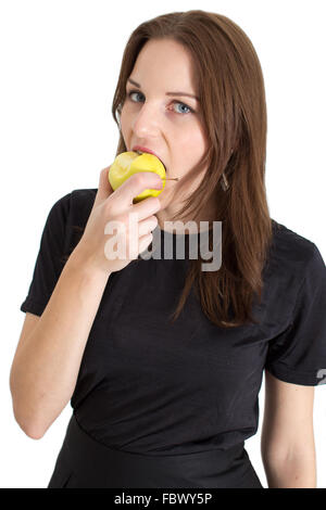 A portrait of a woman biting a green apple with her mouth wide open ...