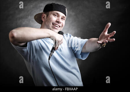 Rap singer man with microphone cool hand gesture Stock Photo - Alamy