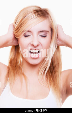 A very frustrated and angry woman is pulling her hair and screaming ...