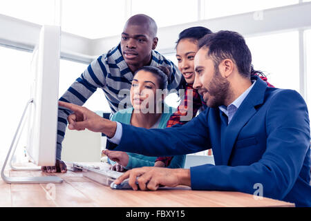Creative businessman explaining colleagues over smartphone Stock Photo ...