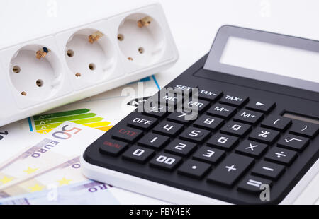 Electric plug, calculator and euro money on the wooden table. Concept ...