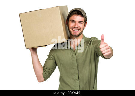Handsome postman holding pack showing thumbs up Stock Photo - Alamy