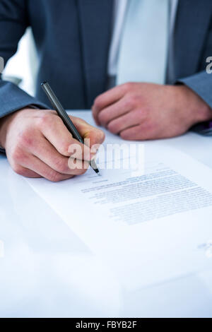 Businessman signing a contract Stock Photo - Alamy