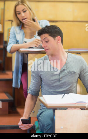 Female student cheating during exam, she is sneaking a look at her ...
