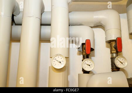 connection heating pipes to white Radiator in a new apartment under ...