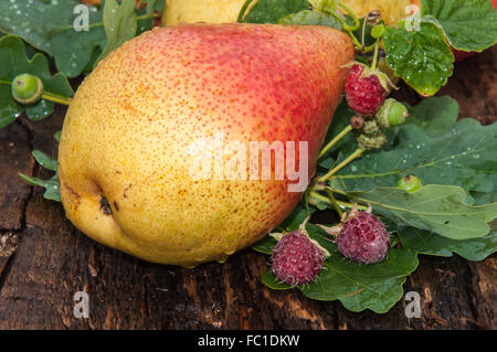 Ripe pear and berry raspberry on wood countertop Stock Photo - Alamy