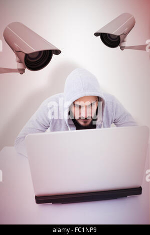 Serious burglar hacking into laptop Stock Photo - Alamy