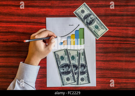Left handed person analyzing charts Stock Photo - Alamy