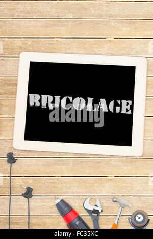 Bricolage against tools and tablet on wooden background Stock Photo - Alamy
