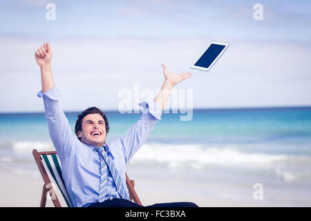 Carefree businessman throwing up his tablet in the air Stock Photo - Alamy
