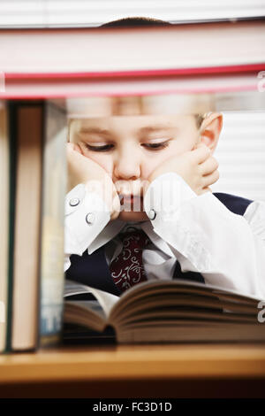 Boy behind books Stock Photo - Alamy