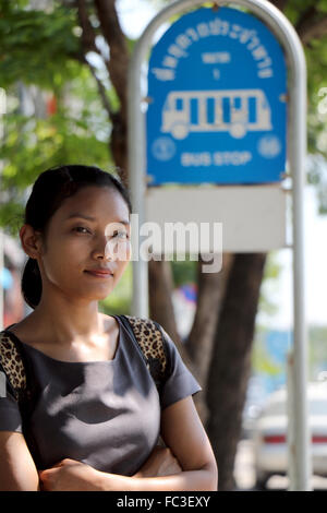 People standing at bus stop waiting Stock Photo - Alamy