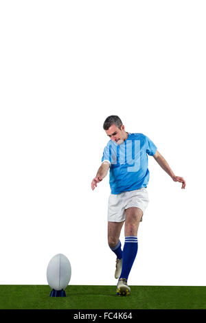 Rugby player doing a drop kick Stock Photo - Alamy