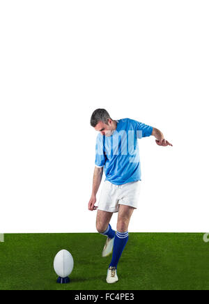 Rugby player doing a drop kick Stock Photo - Alamy