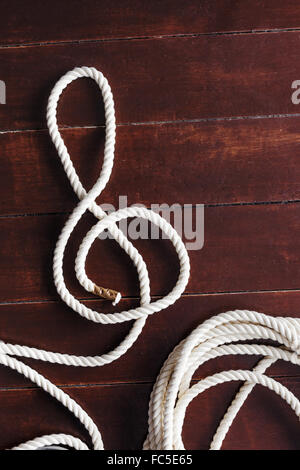 Wooden musical clef on music sheet background Stock Photo - Alamy