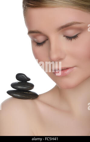 A vertical shot of a pyramid of stones on the rocky shore of the bay ...