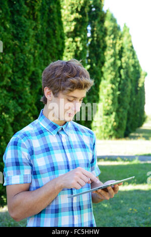 A young man using his Iphone Stock Photo - Alamy