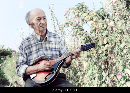 Senior man playing mandolin Stock Photo - Alamy