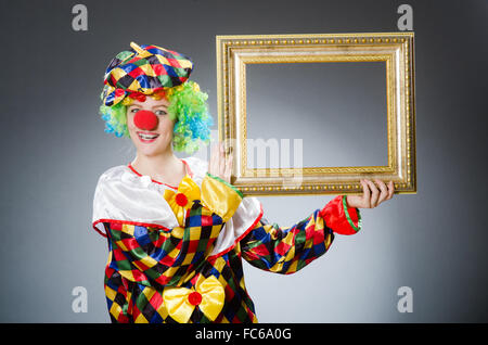 Clown with picture frame in funny concept Stock Photo - Alamy