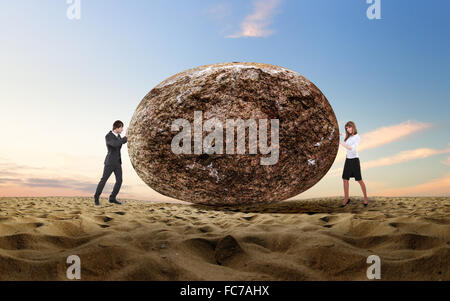 An image of a man rolling a rock uphill Stock Photo: 33940973 - Alamy
